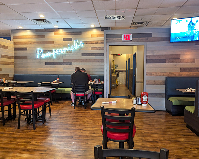 Wood-paneled walls, cozy booths, and that glowing neon sign – Pumpernick's dining room feels like the living room of your favorite food-obsessed relative.