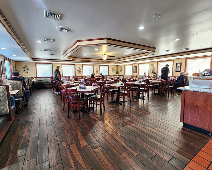 Warm wood floors, red chairs, and that distinctive tray ceiling create the perfect backdrop for breakfast magic. This isn't just dining—it's time travel to when restaurants had soul.