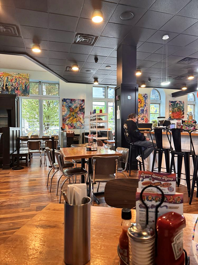Colorful local artwork adorns the walls while natural light floods the modern yet cozy interior—the perfect backdrop for morning revelations over coffee.