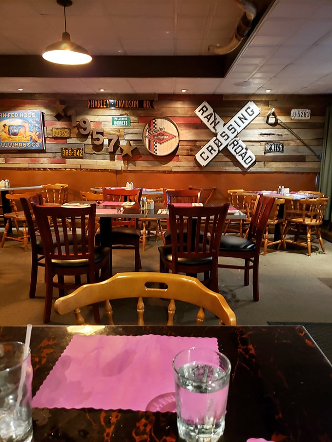 Rustic Americana meets comfort at its finest—where railroad crossing signs and vintage memorabilia create the perfect backdrop for serious steak consumption.