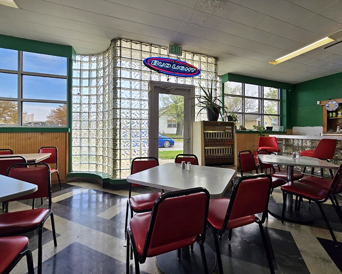 Time travel isn't science fiction here—it's just walking through the door. Glass blocks filter sunlight onto checkerboard floors and cherry-red chairs.