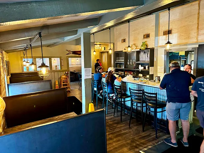 Inside, pendant lights cast a warm glow over the casual dining space where locals and visitors gather to experience seafood that speaks for itself.