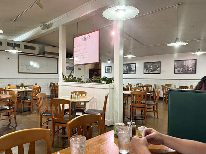 Simple wooden chairs, vintage photos, and the hum of conversation—this isn't interior design, it's deli authenticity that money can't buy.
