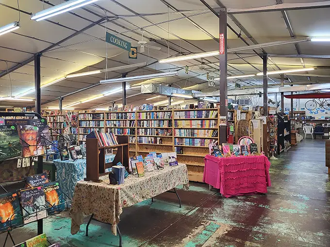 Inside, the adventure begins. Handwritten section signs hang from the ceiling, guiding literary explorers through a labyrinth of well-loved volumes and unexpected discoveries.