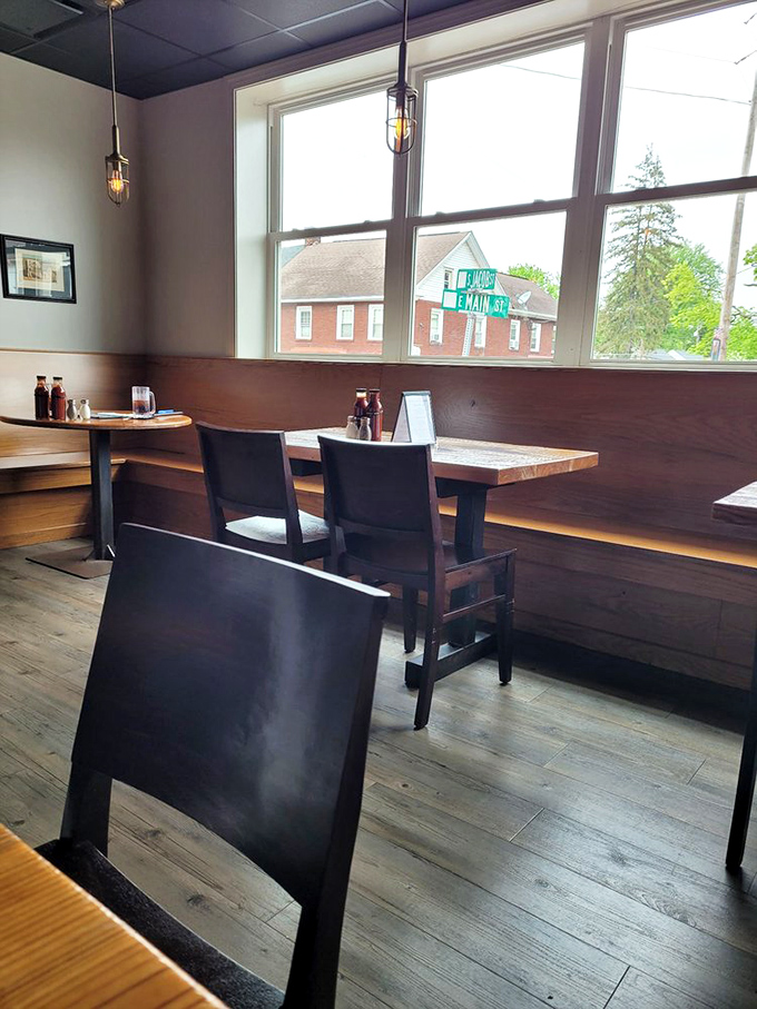 Simple wooden benches and industrial lighting create the perfect stage where the real star—that legendary brisket—can shine without distraction.