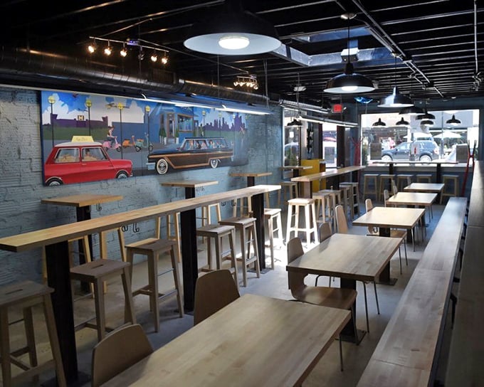 The clean, modern interior features wooden tables and a playful mural of vintage cars—proof that Greek food and Detroit's automotive heritage can happily coexist.