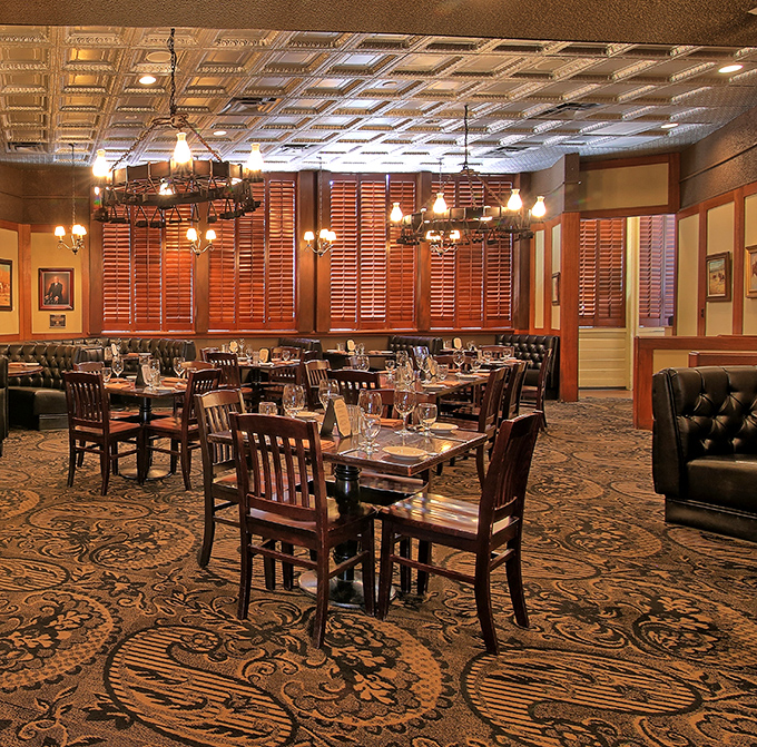 Step inside and time travel to old Arizona elegance – pressed tin ceilings, rich wood paneling, and leather booths create the perfect backdrop for serious steak business.