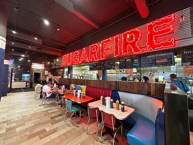 That neon glow isn't just lighting—it's a barbecue bat signal calling hungry St. Louisans to gather around tables where smoke-infused magic happens.