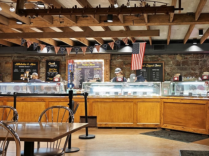 Inside, rustic charm meets sweet indulgence. The stone walls and wooden beams have witnessed generations of ice cream lovers debating the merits of sprinkles versus hot fudge. 