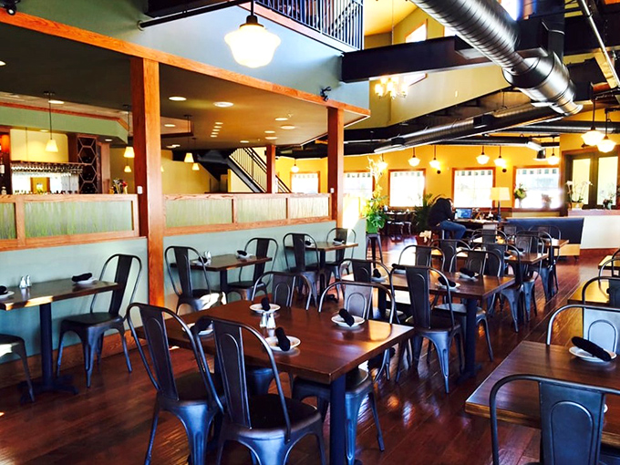 Industrial-chic meets maritime comfort in Youell's spacious dining room, where wooden tables and metal chairs create the perfect backdrop for seafood feasting.