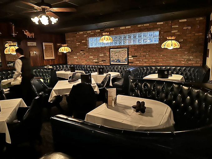 Step inside to find a time capsule of classic steakhouse charm, where tufted leather booths and warm lighting create the perfect backdrop for memorable meals.