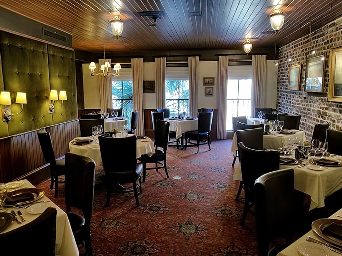 Step inside and discover an intimate dining room where exposed brick meets white tablecloths – the stage is set for culinary theater at its finest.