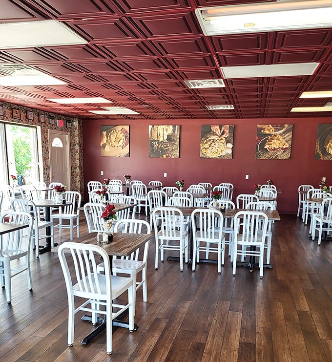 Inside, burgundy ceiling tiles and wooden floors create the perfect backdrop for pie contemplation. The white chairs aren't just waiting for customers – they're awaiting conversion experiences.