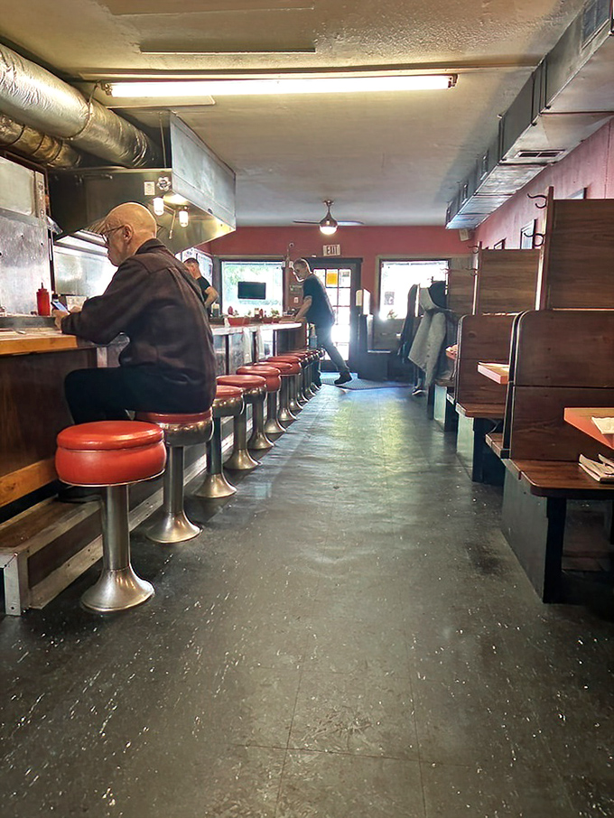 Classic red vinyl stools await hungry patrons at the counter. This isn't retro by design—it's authentic by survival.