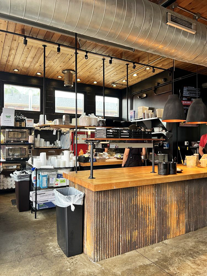 Industrial chic meets meat sanctuary. The wooden ceiling and corrugated metal counter aren't designed to impress Instagram—they're designed for serious barbecue business.