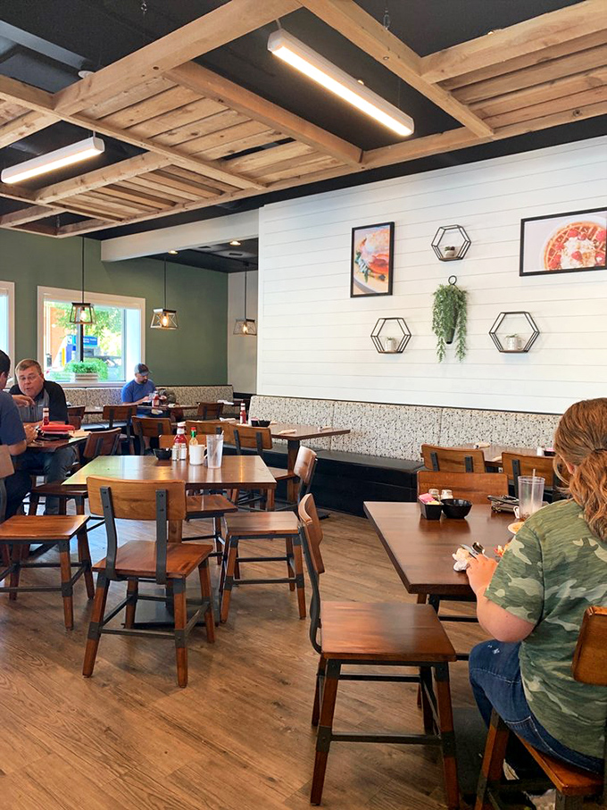 Exposed wooden beams and shiplap walls create a space that feels both modern and homey—like if Joanna Gaines designed your favorite aunt's kitchen.