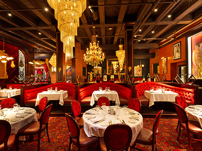 Red velvet booths, crystal chandeliers, and enough ambiance to make you sit up straighter. This isn't dinner – it's dinner theater.