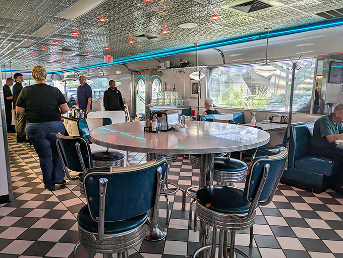 The quintessential diner interior—checkered floors, blue vinyl seats, and that counter where breakfast dreams come true. This isn't Instagram bait; it's the real deal.