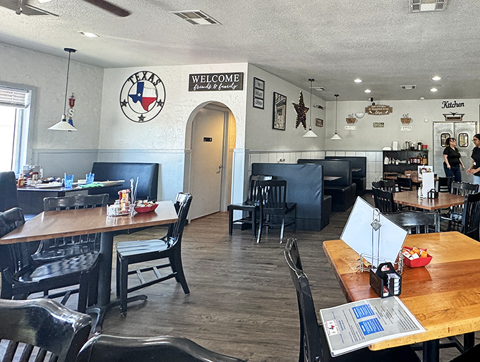 Classic blue booths and Texas pride on full display. This isn't interior design – it's comfort engineering at its finest.
