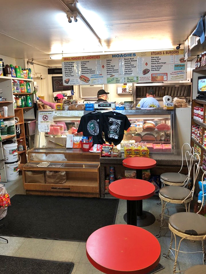 Inside, time stands still in the best possible way. Those vintage red counter stools aren't just seats—they're front-row tickets to sandwich artistry.