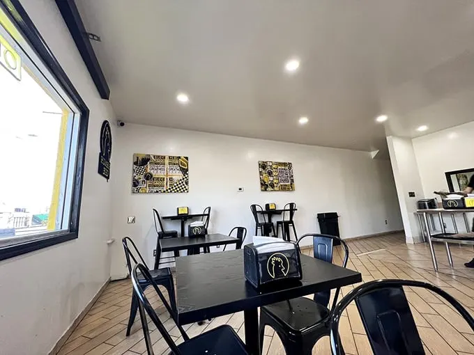 Minimalism at its finest—black tables, white walls, and zero distractions from the main event that's about to arrive at your table.
