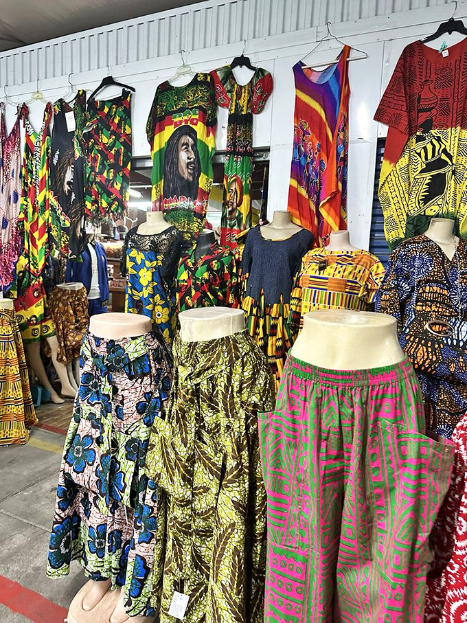 A kaleidoscope of culture hangs in vibrant rows. These colorful garments aren't just clothes—they're wearable stories waiting for their next chapter.