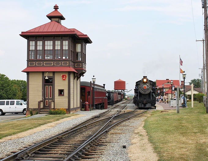 All aboard for time travel! Strasburg's historic railway station, complete with vintage signal tower and gleaming steam locomotive, promises adventures that clickety-clack into the past.