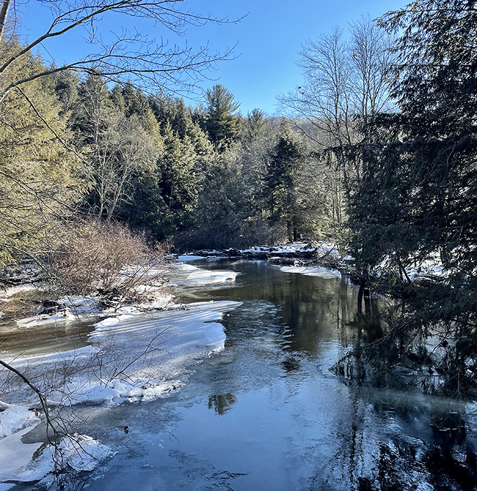 Winter transforms Nescopeck Creek into a scene straight from a holiday card. Half-frozen waters whisper promises of spring beneath their icy blanket.