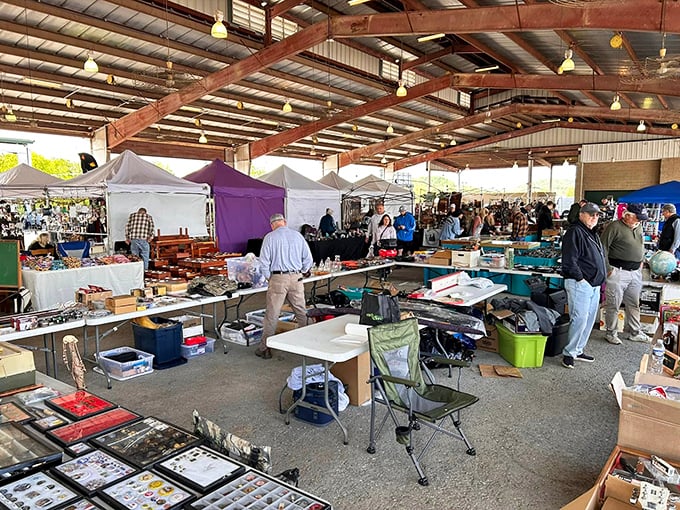Beneath the rustic beams, shoppers navigate a maze of possibility. Every table holds someone's past and another's future—the beautiful chaos of flea market magic.