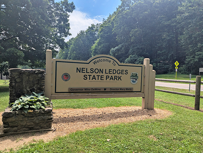 The gateway to adventure doesn't need neon lights. This unassuming sign marks the entrance to one of Ohio's most dramatic geological wonders.