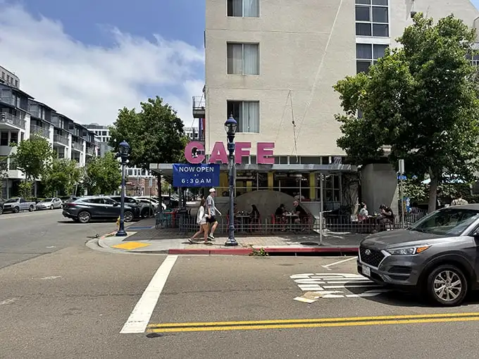 The pink "CAFE" sign beckons like a neon promise of breakfast nirvana – San Diego's morning happy place.