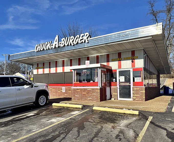 Chuck-A-Burger's red and white striped awning stands like a beacon for burger lovers seeking that perfect nostalgic bite.