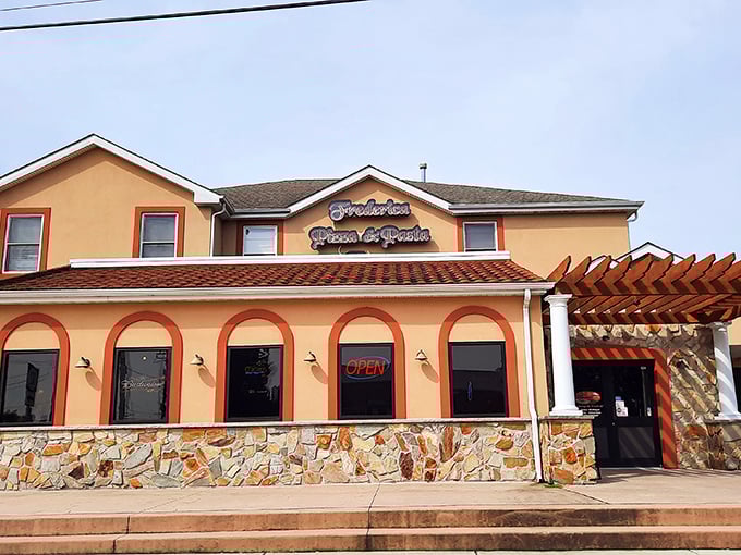Frederica Pizza's bold orange facade stands out like a sunset. This isn't just a restaurant—it's a landmark for hungry travelers.