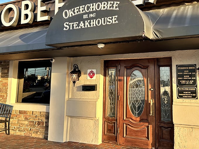 That elegant wooden door at Okeechobee Steakhouse isn't just an entrance – it's a time portal to steak perfection.