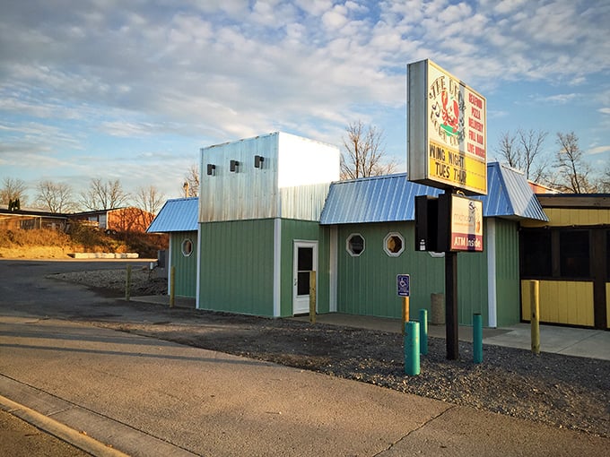 The Deck Down Under's mint-green exterior and porthole windows – nautical charm in the heart of Jerome.