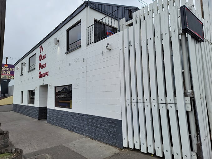 Ye Olde Pizza Shoppe's distinctive white slat exterior stands out like a pizza fortress in Hermiston—simple, sturdy, and hiding delicious treasures.