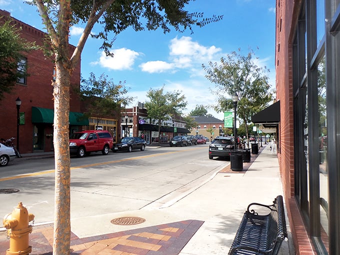 Clean sidewalks and friendly storefronts create the perfect small-town strolling experience you remember.