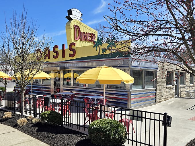 Those cheerful yellow umbrellas aren't just for show—they're beacons calling you to pancake paradise at this meticulously preserved slice of roadside Americana.