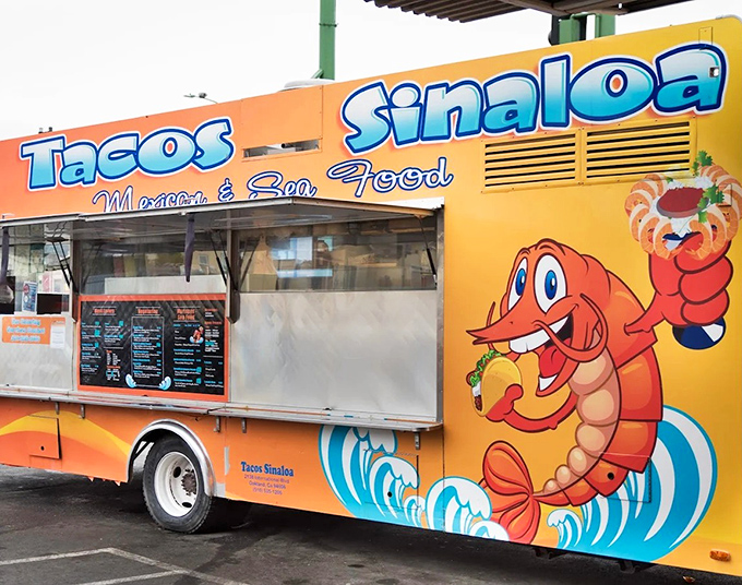 This bright orange taco truck isn't just eye-catching—it's a flavor beacon for seafood taco aficionados. Sinaloa's shrimp mascot knows what's up!
