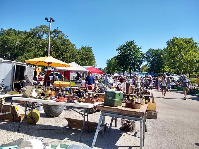 Tools, hats, and mysteries galore! This outdoor vendor's table is like your grandpa's workshop crossed with a department store.