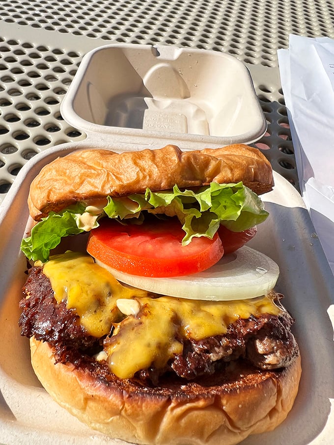 Behold burger nirvana: a perfectly charred patty, melted cheese, fresh veggies, and that toasted bun. This is what dreams are made of.