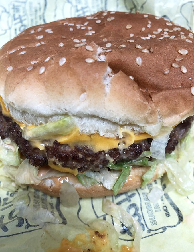 Behold the cheeseburger in its natural habitat – a perfect symphony of beef, cheese, and fresh toppings that puts fast food chains to shame.