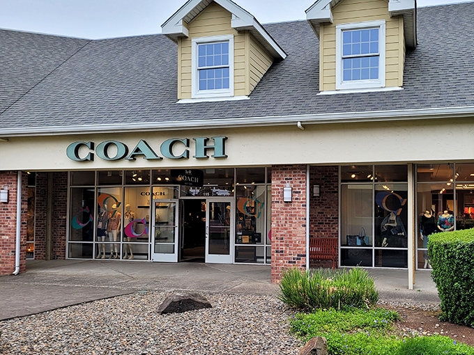The Coach store beckons with promises of leather luxury at less painful prices. That brick facade can't hide the designer deals waiting inside.