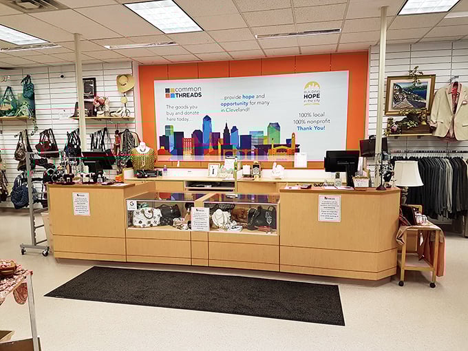 Behind this unassuming counter, dreams and bargains unite. The orange backdrop featuring Cleveland's skyline reminds you this is shopping with purpose.