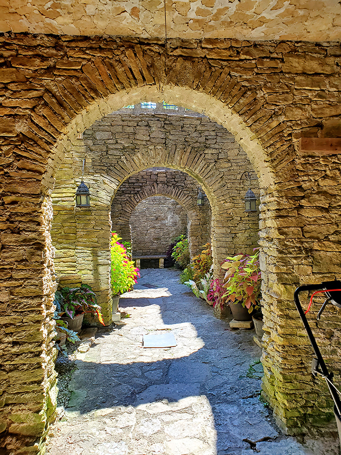 Walking through these ancient-style archways feels like stepping into a time machine set for medieval times.