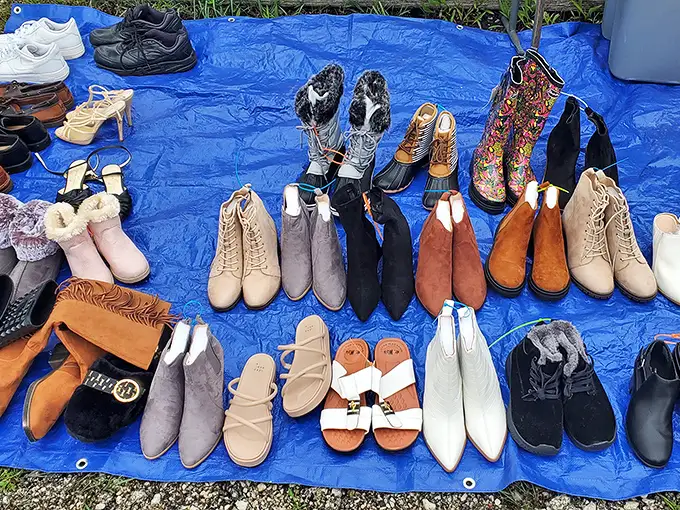 A rainbow of footwear possibilities spread across blue tarp—like Cinderella's closet, if Cinderella had excellent taste and bargain-hunting skills.