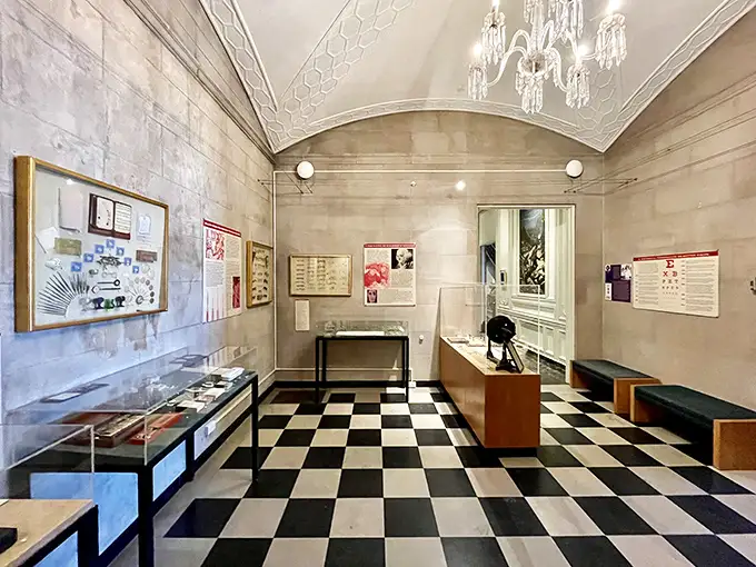 Black and white checkered floors and crystal chandeliers—because nothing says "let's examine medical history" quite like unexpected elegance.