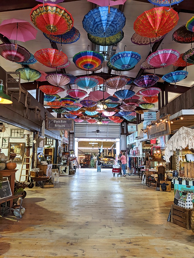 A ceiling of suspended umbrellas creates an Instagram-worthy canopy above this indoor section, where antiques and collectibles await discovery below.