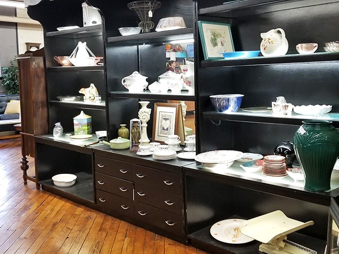 Grandma's china cabinet has nothing on this display. Vintage teapots and serving dishes wait patiently for their second act in someone's dining room drama.