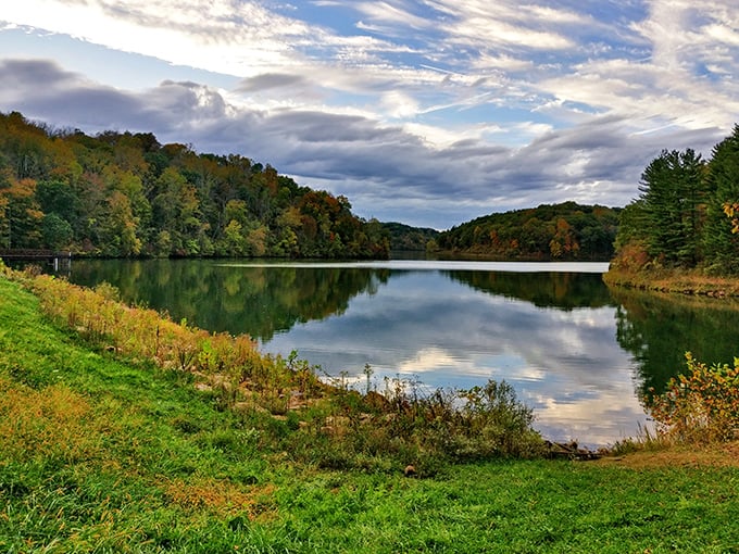 Mirror, mirror on the lake—Dow Lake's glass-like surface perfectly reflects Ohio's dramatic skies, creating twice the beauty in a single glance.